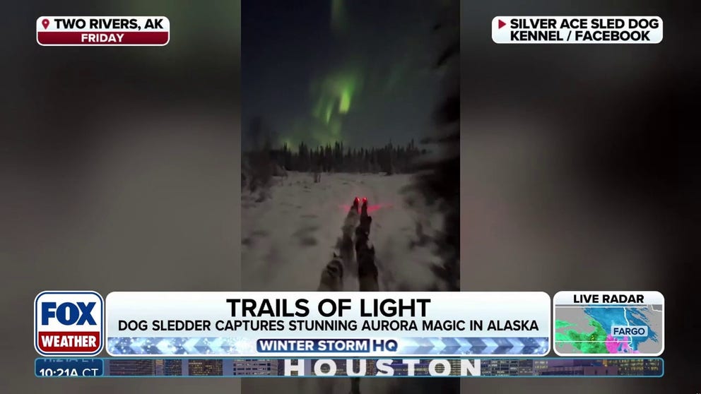 Aurora borealis shines overhead of a dog sledder | Latest Weather Clips ...