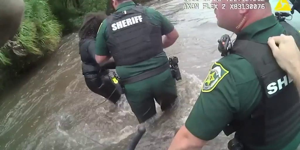Watch: Police rescue woman trapped in surging waters | Latest Weather ...