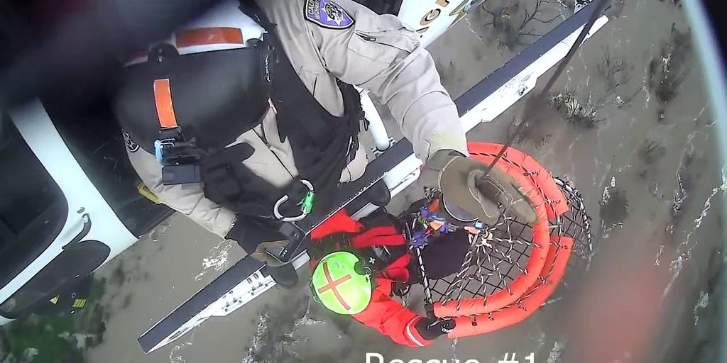 Watch: Video shows dramatic rescue of drivers trapped by rising ...