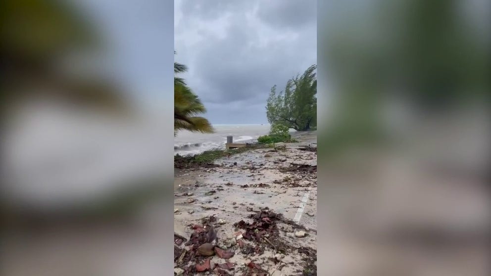 Hurricane Ian waves wash debris onto coastal road in the Cayman Islands ...