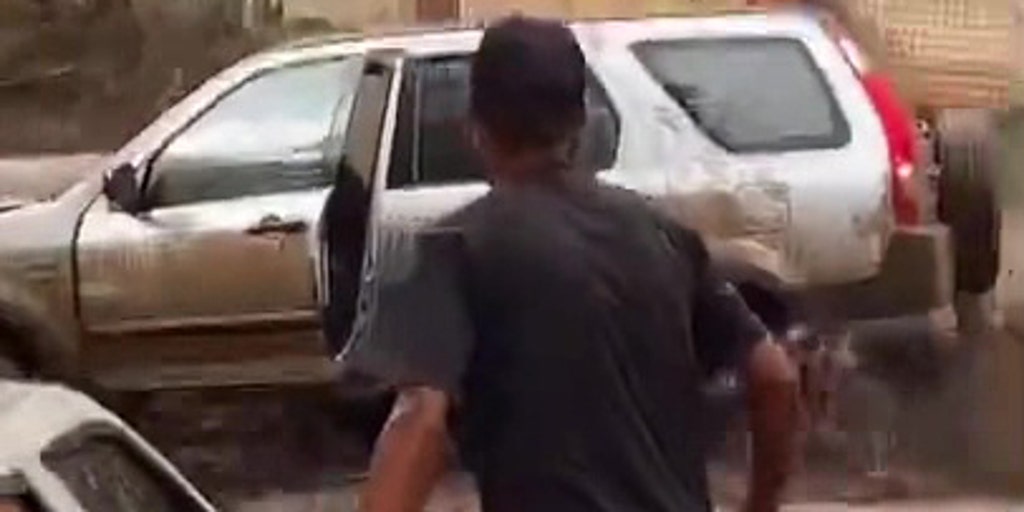 Watch: Man nearly swept away as raging mudslide sweeps through ...