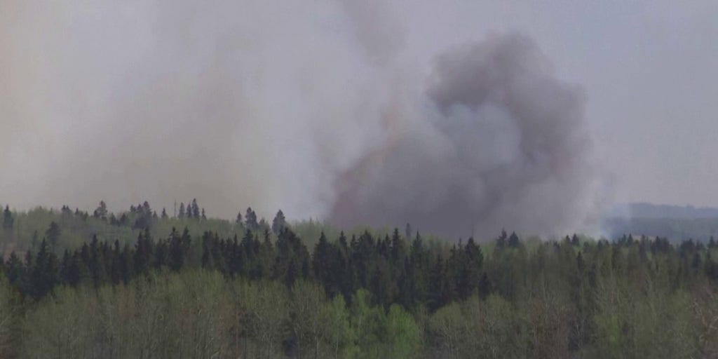 Wildfires rage across Alberta forcing more than 24,000 to flee their ...
