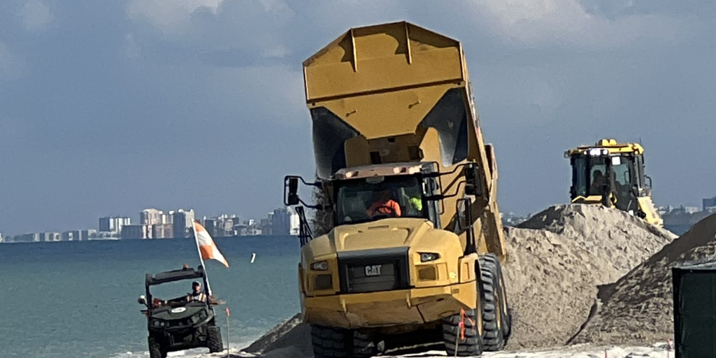 300 dump trucks traverse Florida neighborhood each day to restore dunes ...
