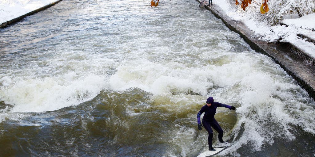Surfers ride Munich’s famous river wave during heavy snowfall | Fox Weather